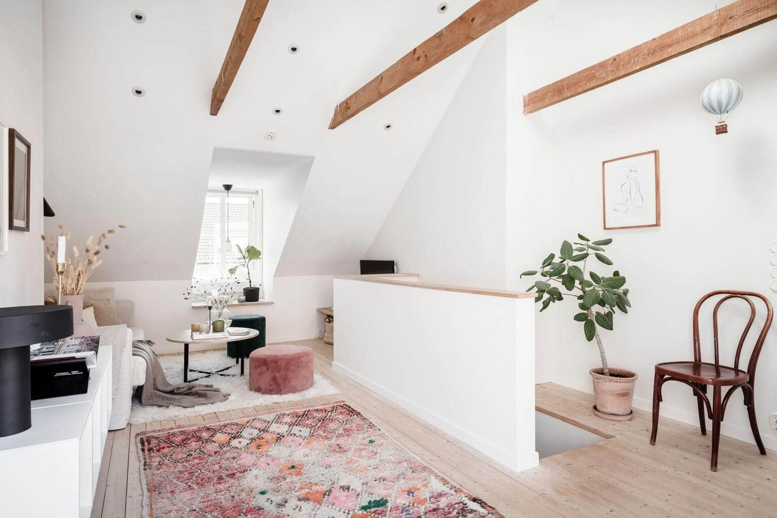A Living Room with Pink Accents in a Light Attic Apartment - The Nordroom