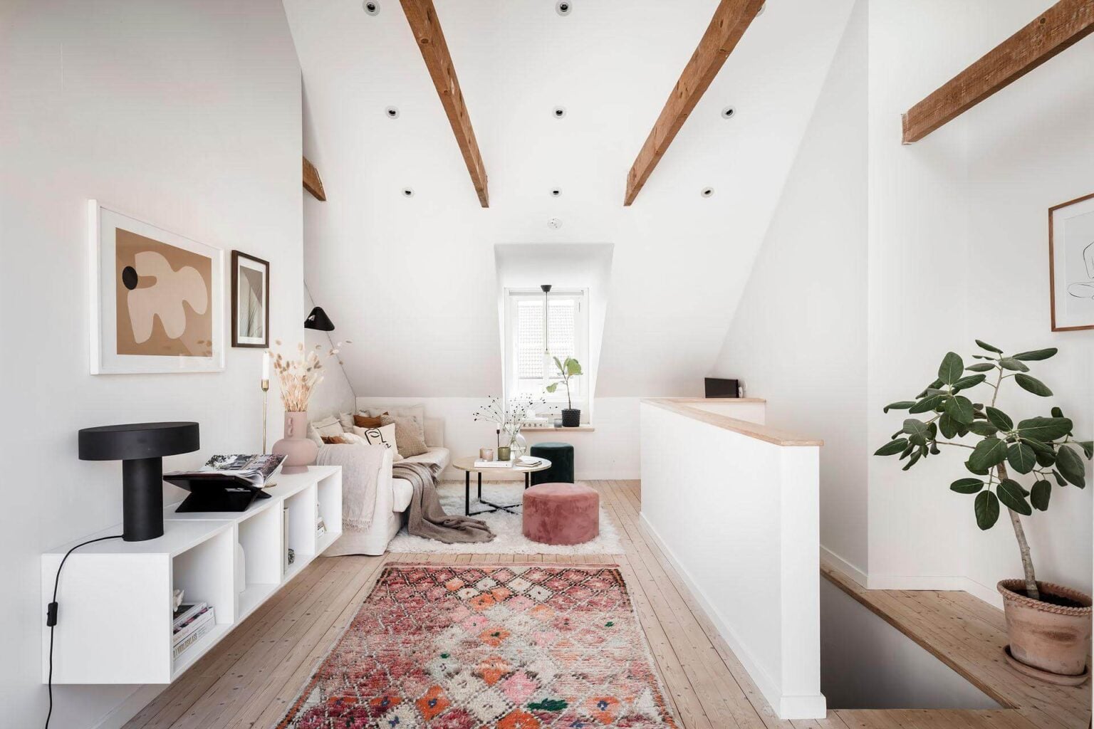 A Living Room with Pink Accents in a Light Attic Apartment - The Nordroom