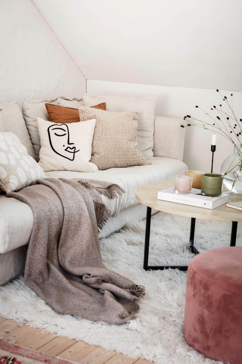 A Living Room with Pink Accents in a Light Attic Apartment - The Nordroom