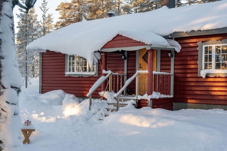 A Gray Swedish Log House Decorated for Christmas - The Nordroom