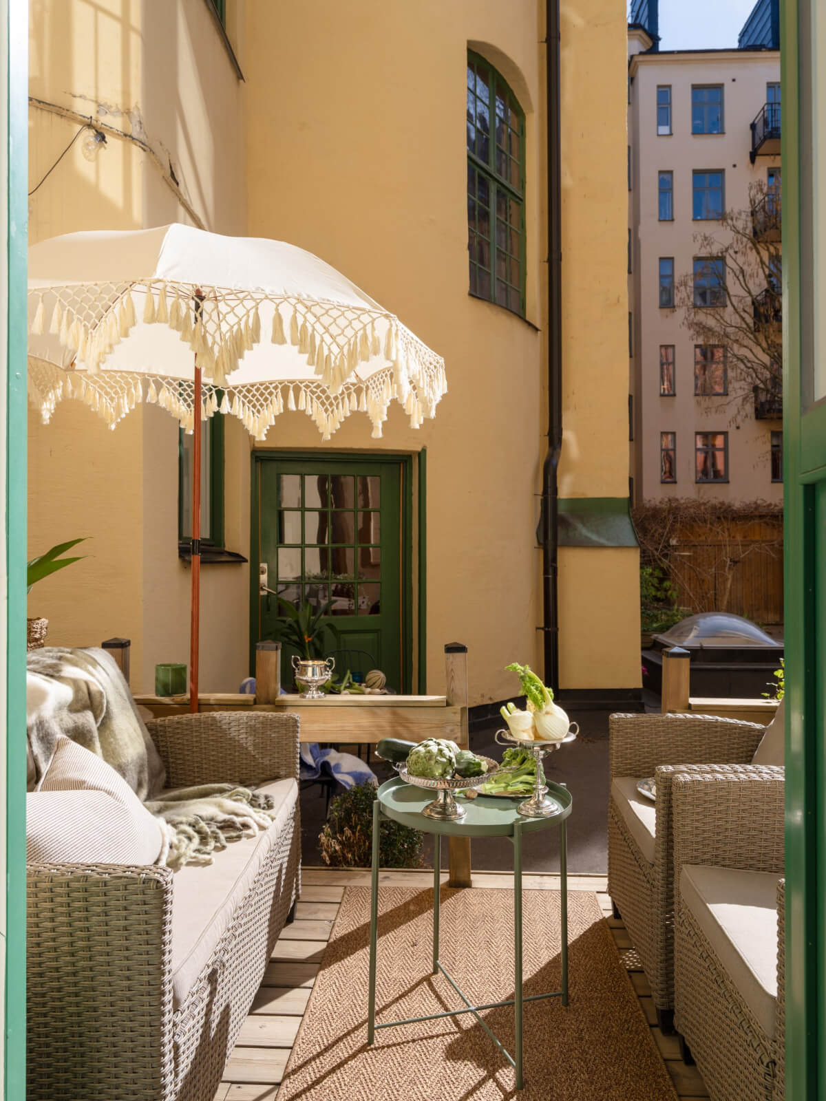 A Small Apartment with Green Color Accents and a Cozy Patio Terrace ...